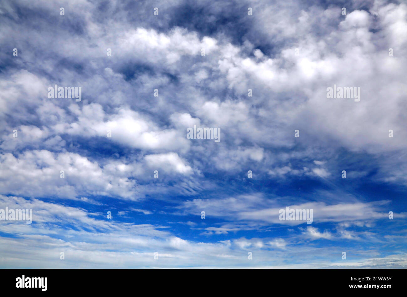 many white clouds of all shapes in the blue sky Stock Photo - Alamy