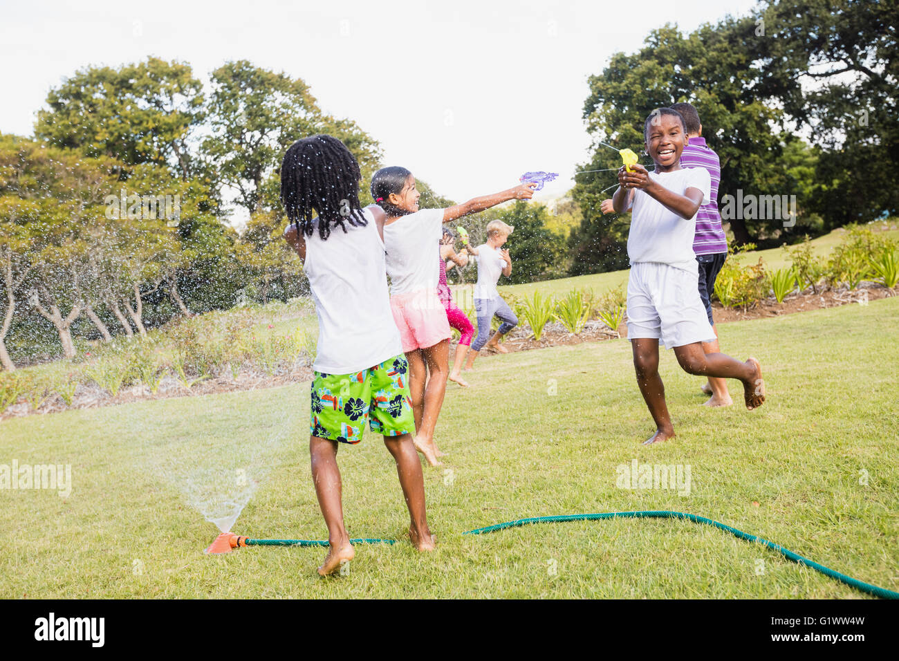 Kids playing together during a sunny day Stock Photo - Alamy
