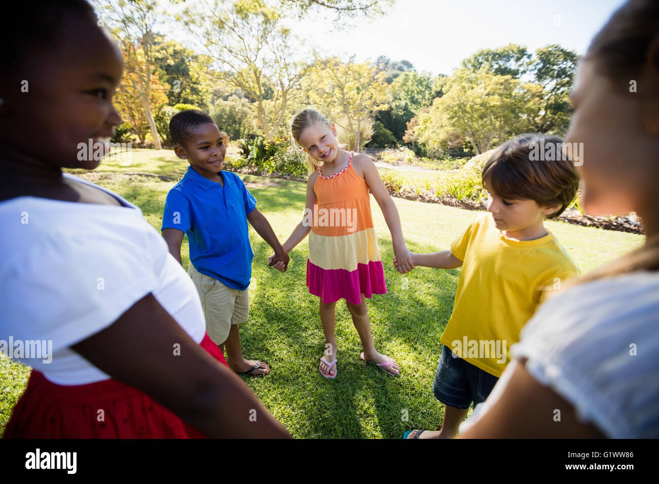 Kids playing together during a sunny day Stock Photo - Alamy