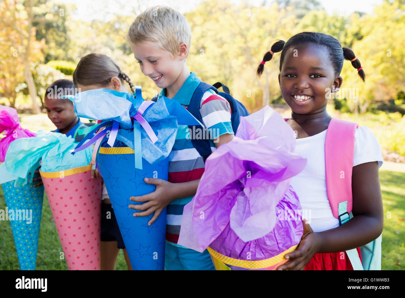 Kids posing with their gift surprise during a sunny day Stock Photo - Alamy