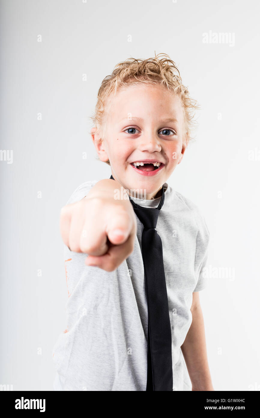 happy boy pointing out to you because he spotted you among the others ...