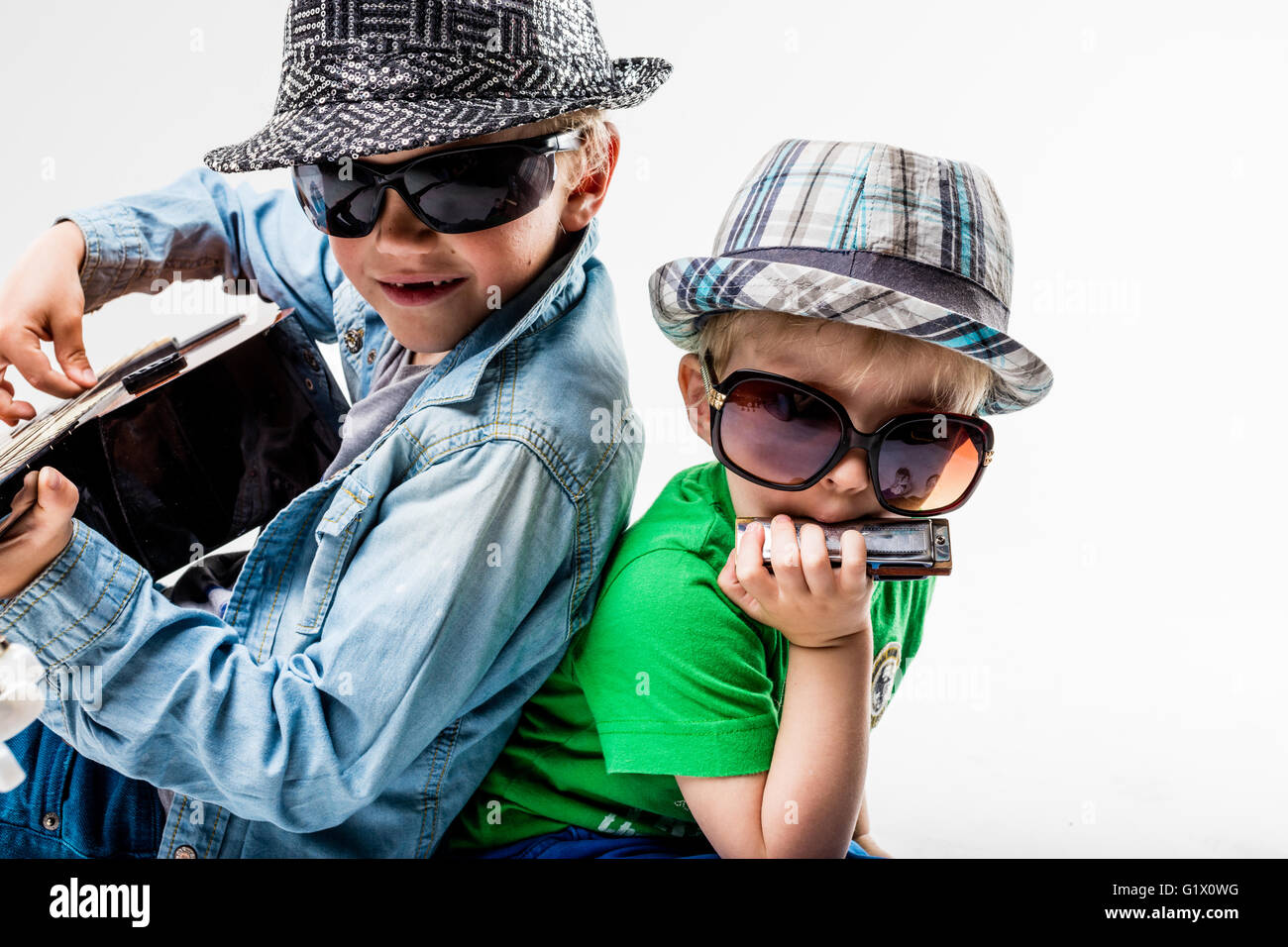 Two boys playing guitar and singing hi-res stock photography and images ...