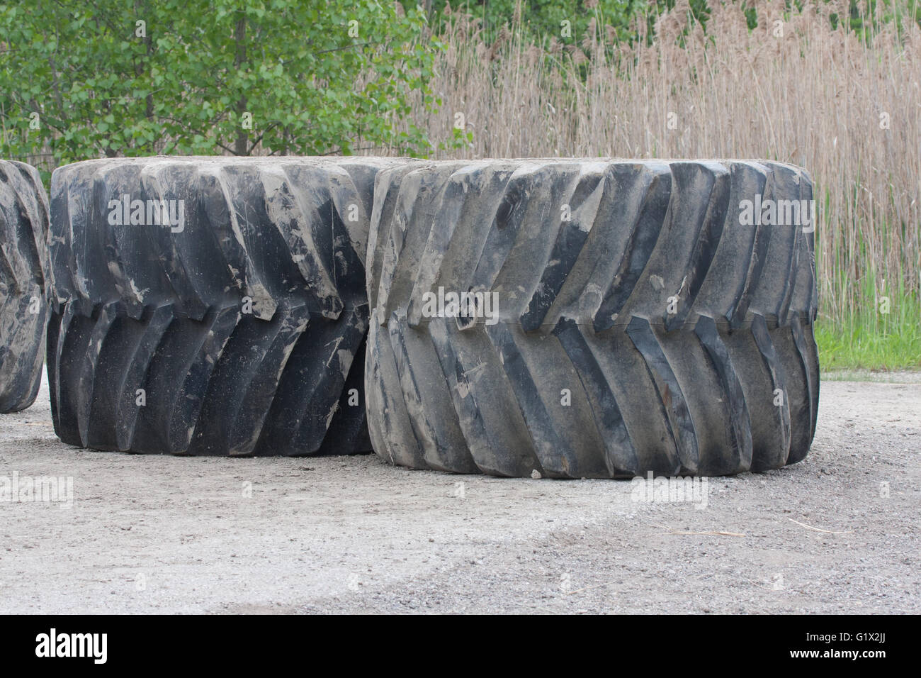 Giant Machinery Rubber Tires laying in a field Stock Photo - Alamy