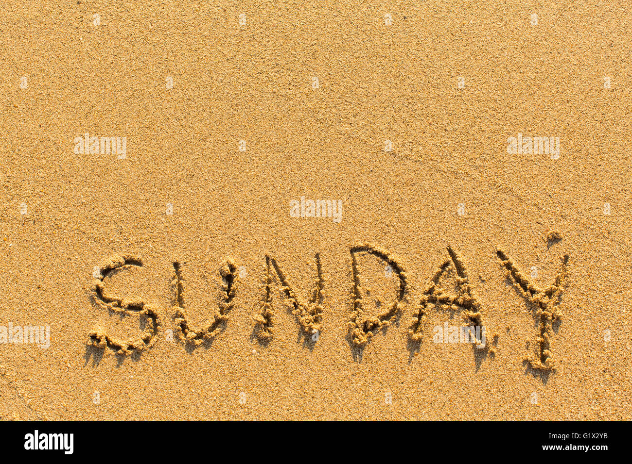 Sunday - inscription by hand on a light-golden beach sand Stock Photo ...