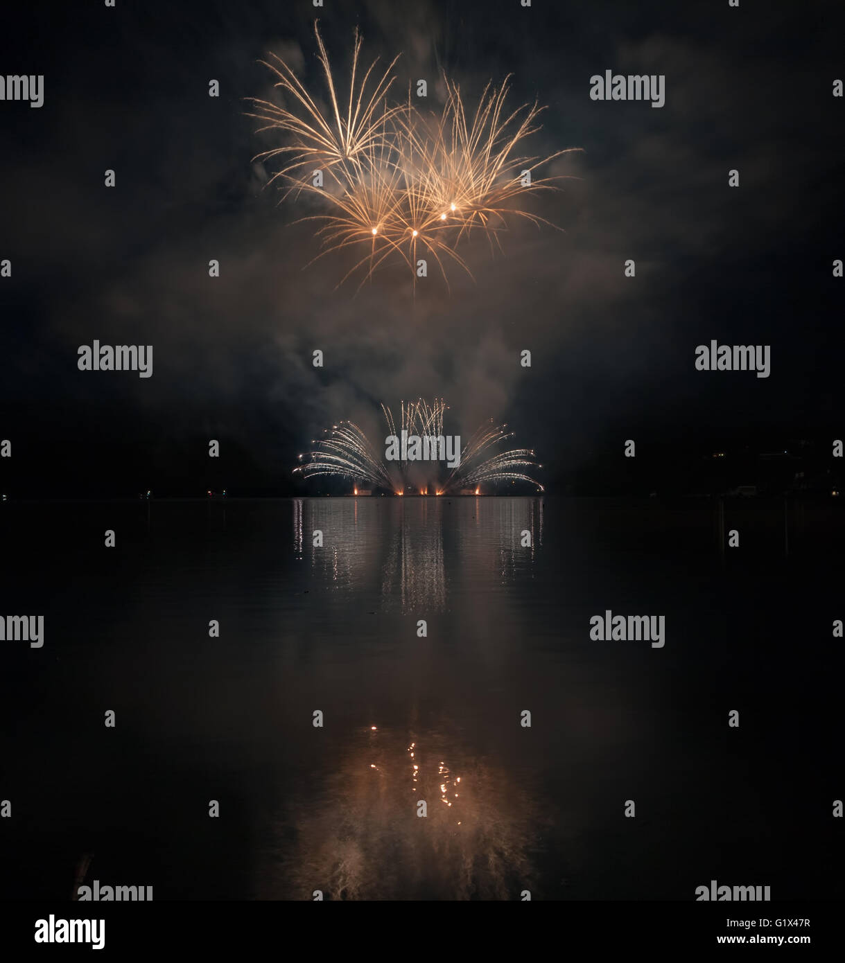 Colorful fireworks with reflection on lake and night sky in background ...