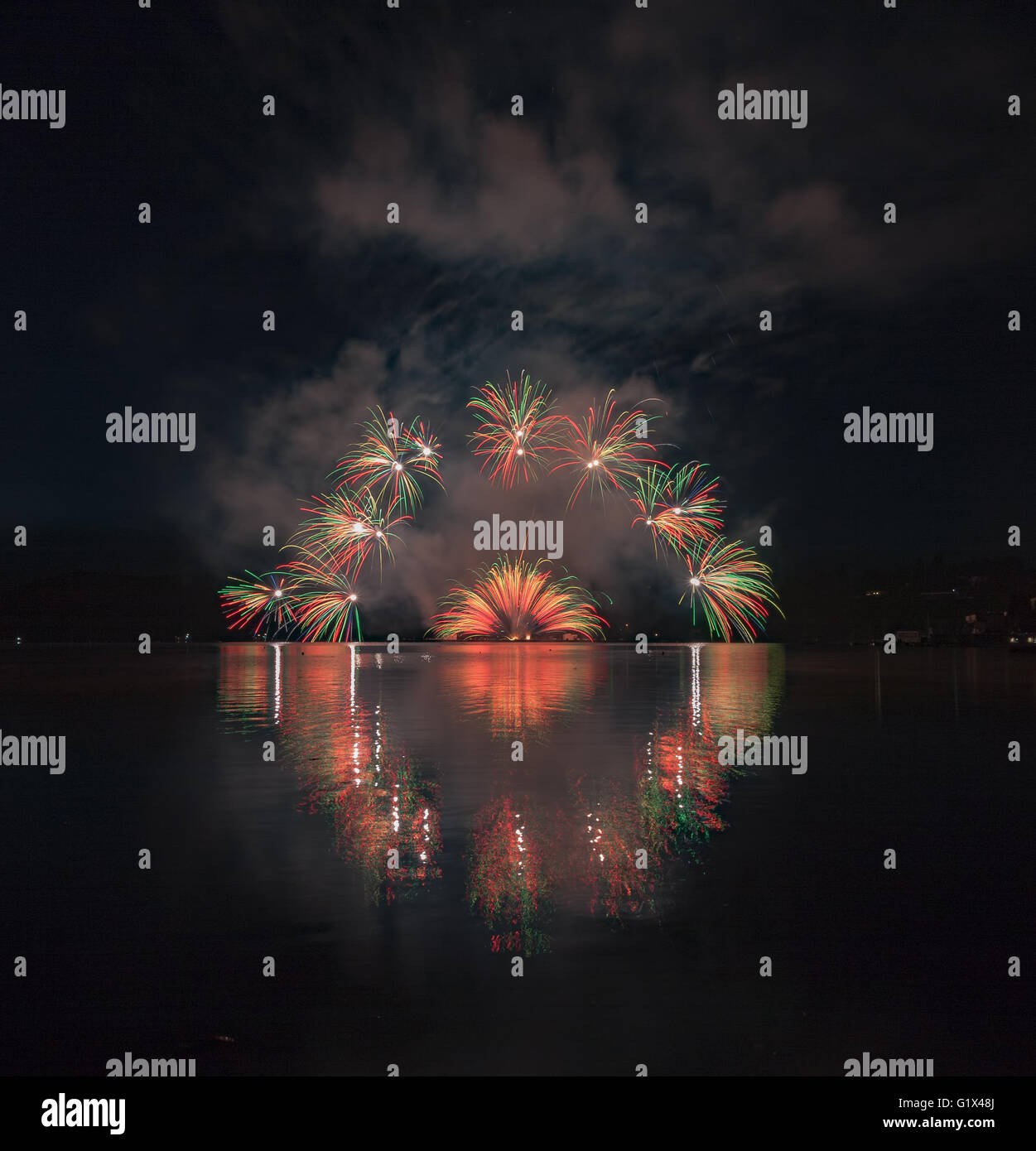 Colorful fireworks with reflection on lake and night sky in background ...