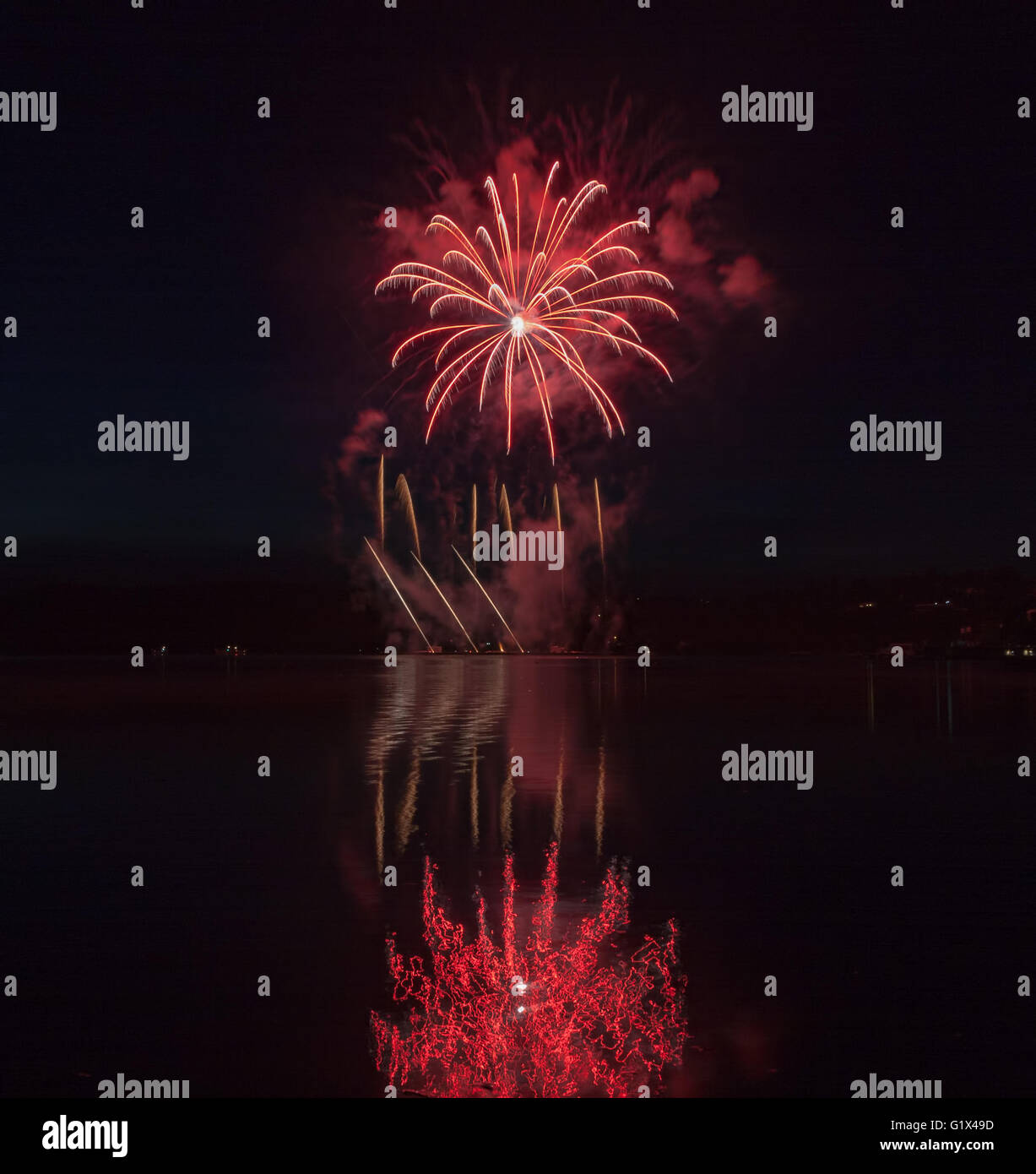 Colorful fireworks with reflection on lake and night sky in background ...