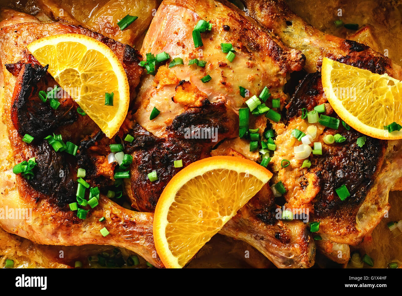Background of baked chicken in oranges and spices Stock Photo - Alamy