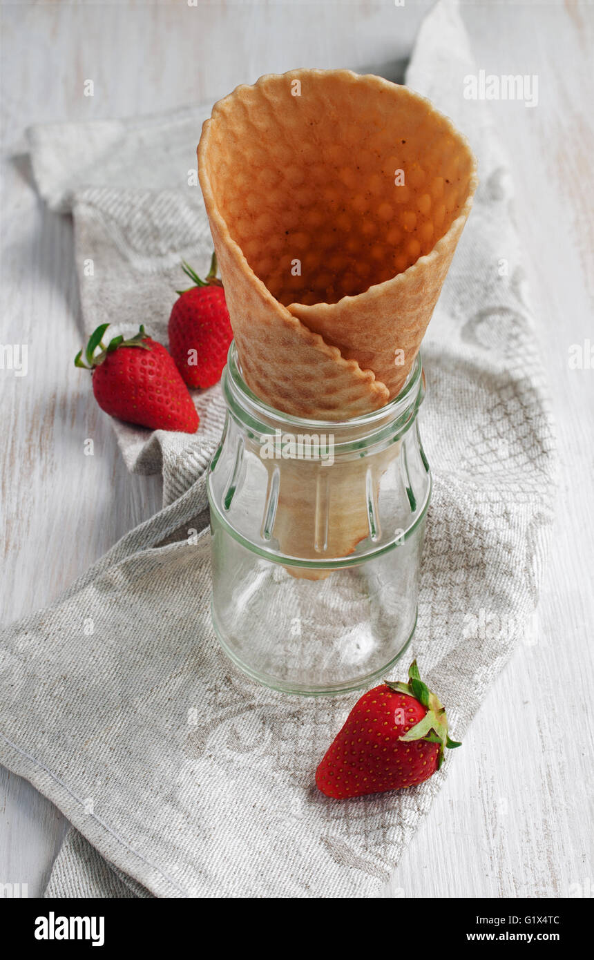 Empty waffle cone for ice cream and fresh strawberries Stock Photo - Alamy