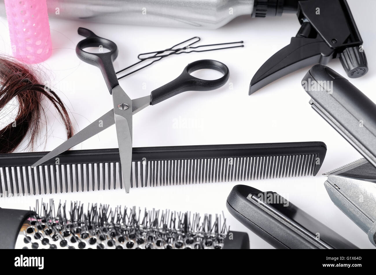 composition hairdressing tools on a white table and white background ...