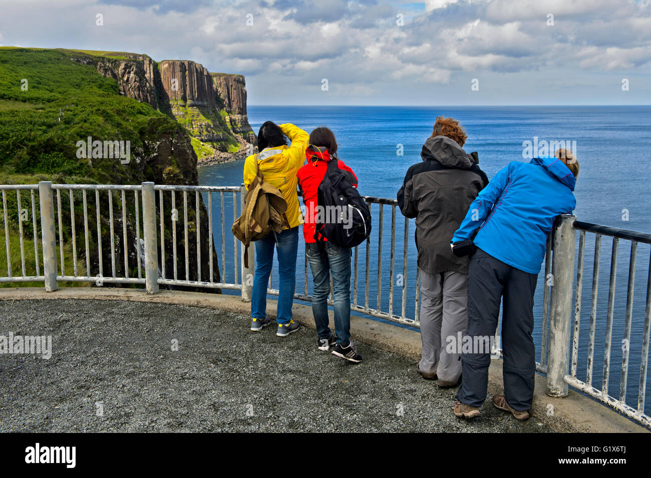 Tourists on the view point of the Kilt Rock Basaltic cliffs at Staffin ...