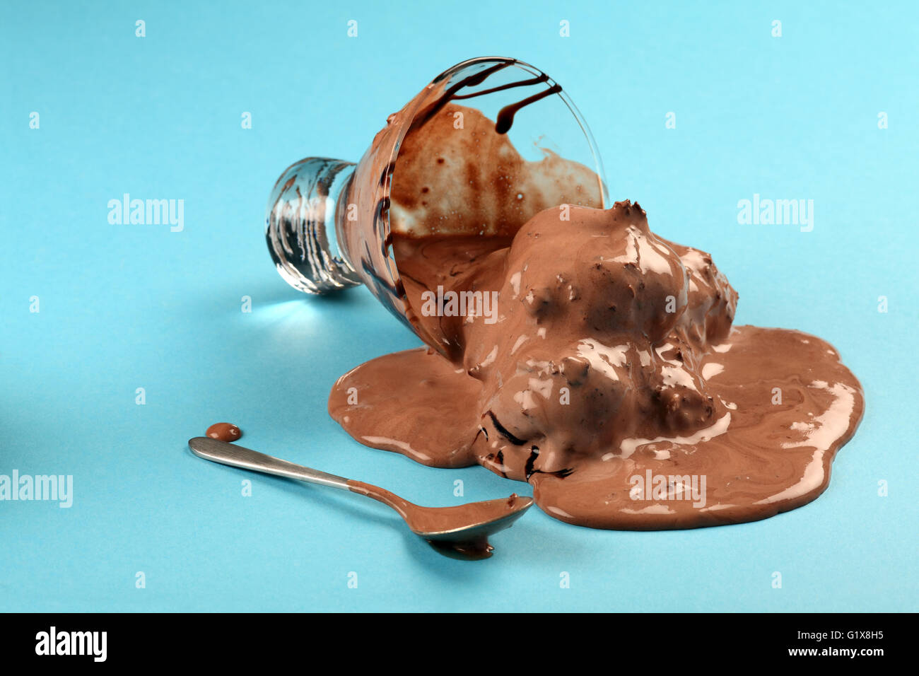 Photo of a bowl of melting chocolate ice cream tipped over and melting ...