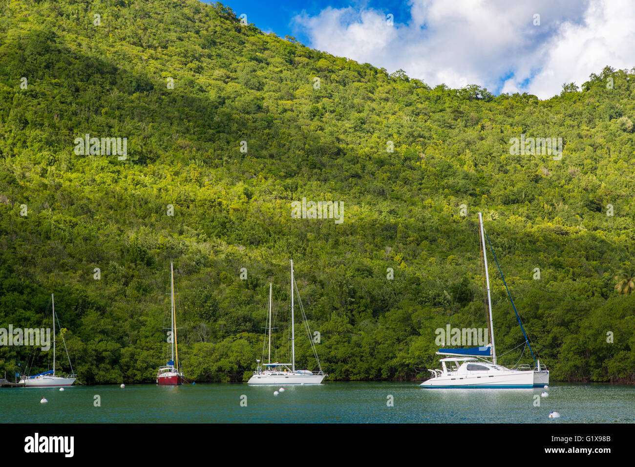 Boats moored in the tiny harbor at Marigot Bay, St. Lucia, West Indies ...