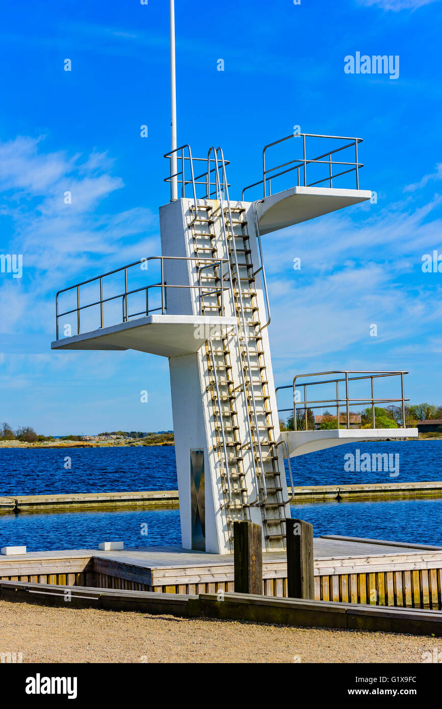 Detail of a white public diving tower or diving platform against a blue ...