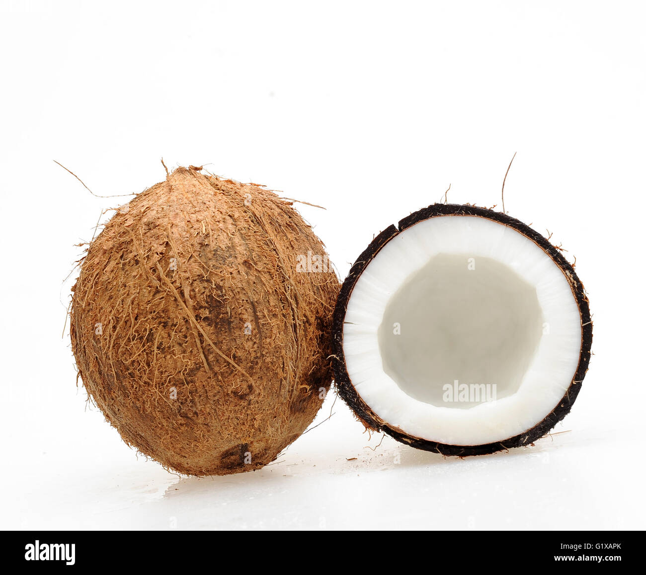 Round coconut and cracked coconut fruit isolated Stock Photo - Alamy