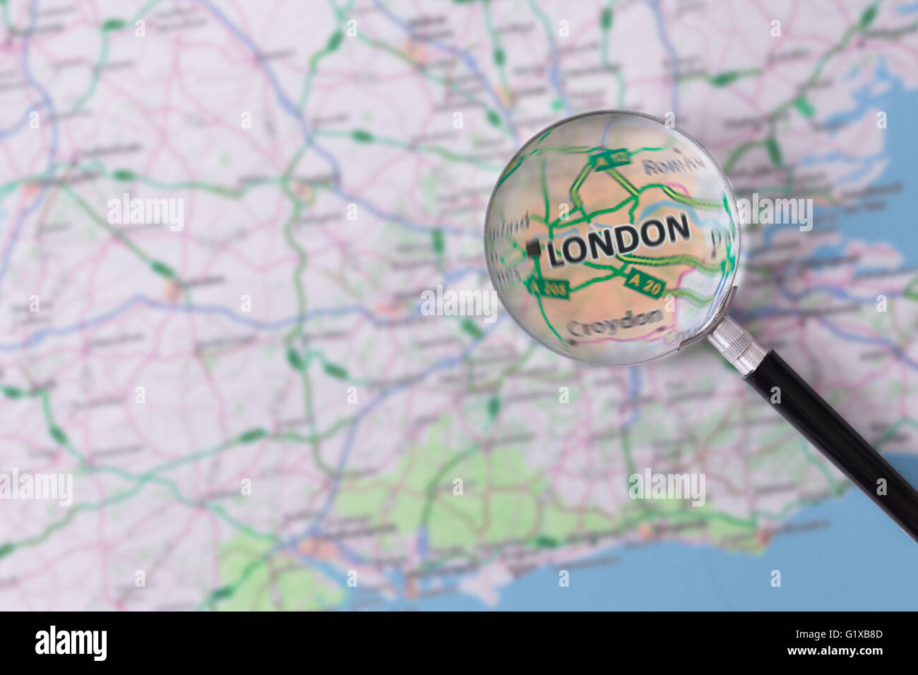 Map of London consulted with a magnifying glass highlighting the name ...