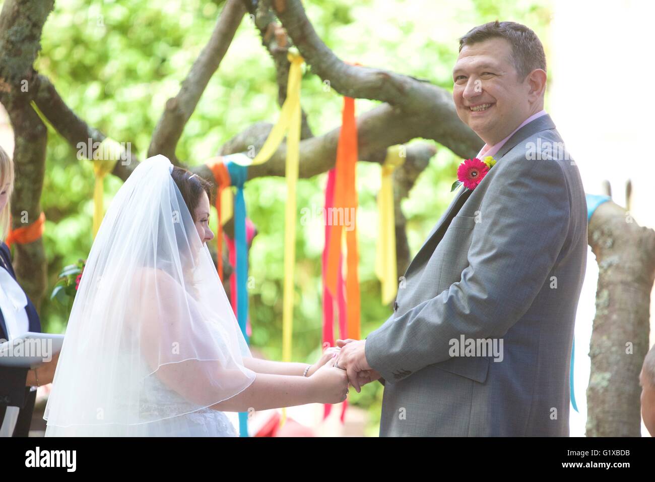 Groom Smiling at alter during wedding vows Stock Photo - Alamy