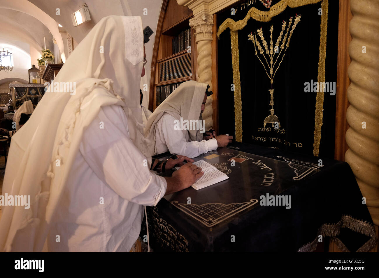 Ultra orthodox Jews wrapped with Talit shawl pray inside the burial ...