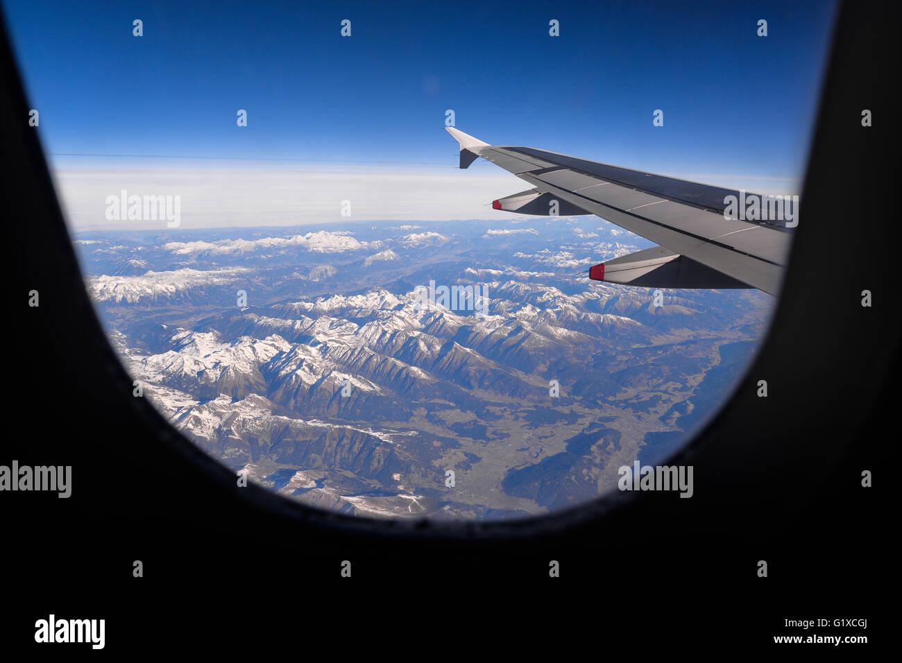 Wing of an airplane flying over alps hi-res stock photography and ...