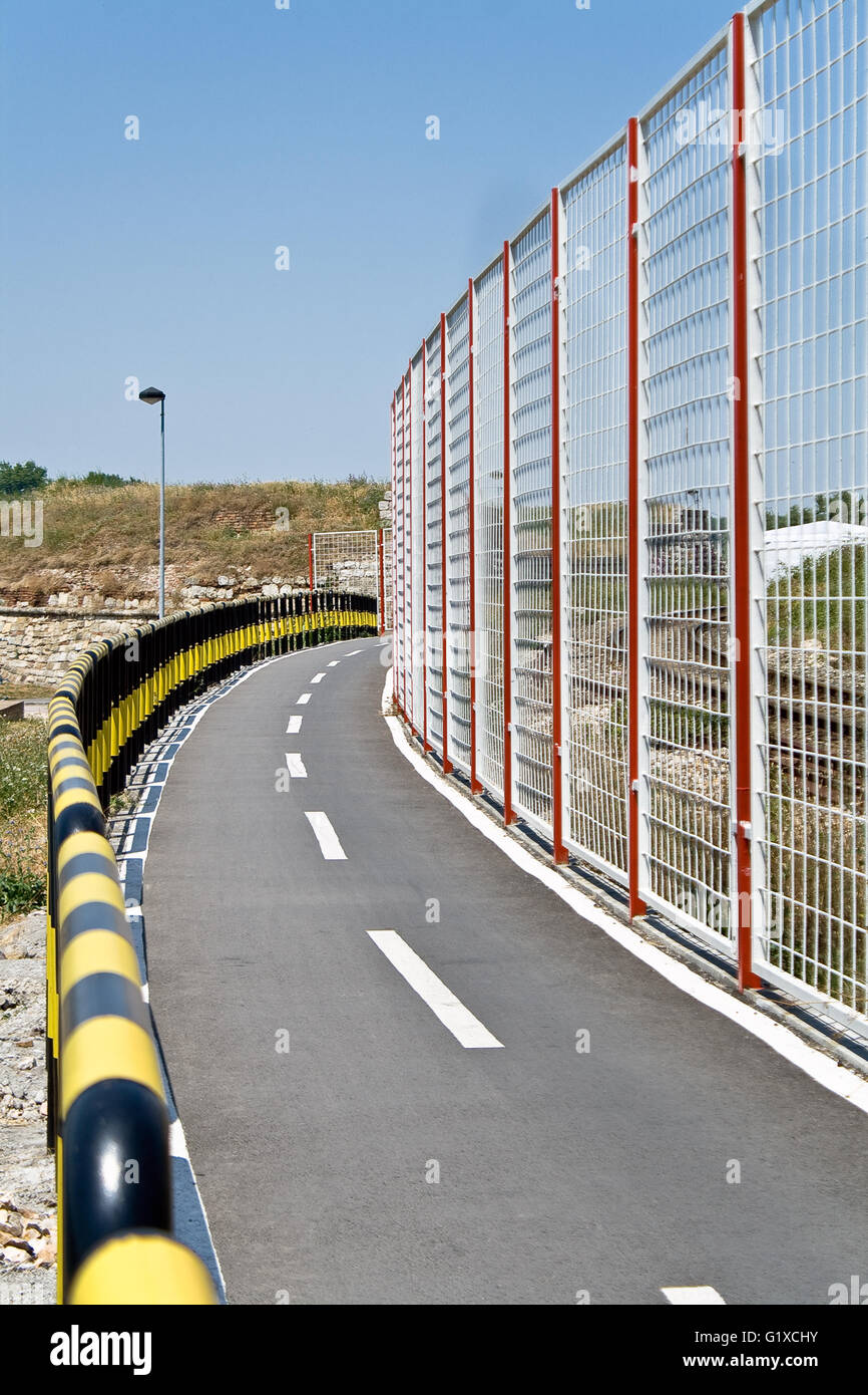 Bicycle path and fence Stock Photo - Alamy