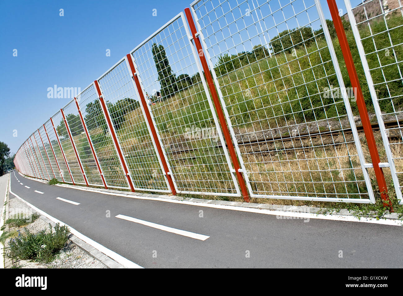 Bicycle path and fence Stock Photo - Alamy