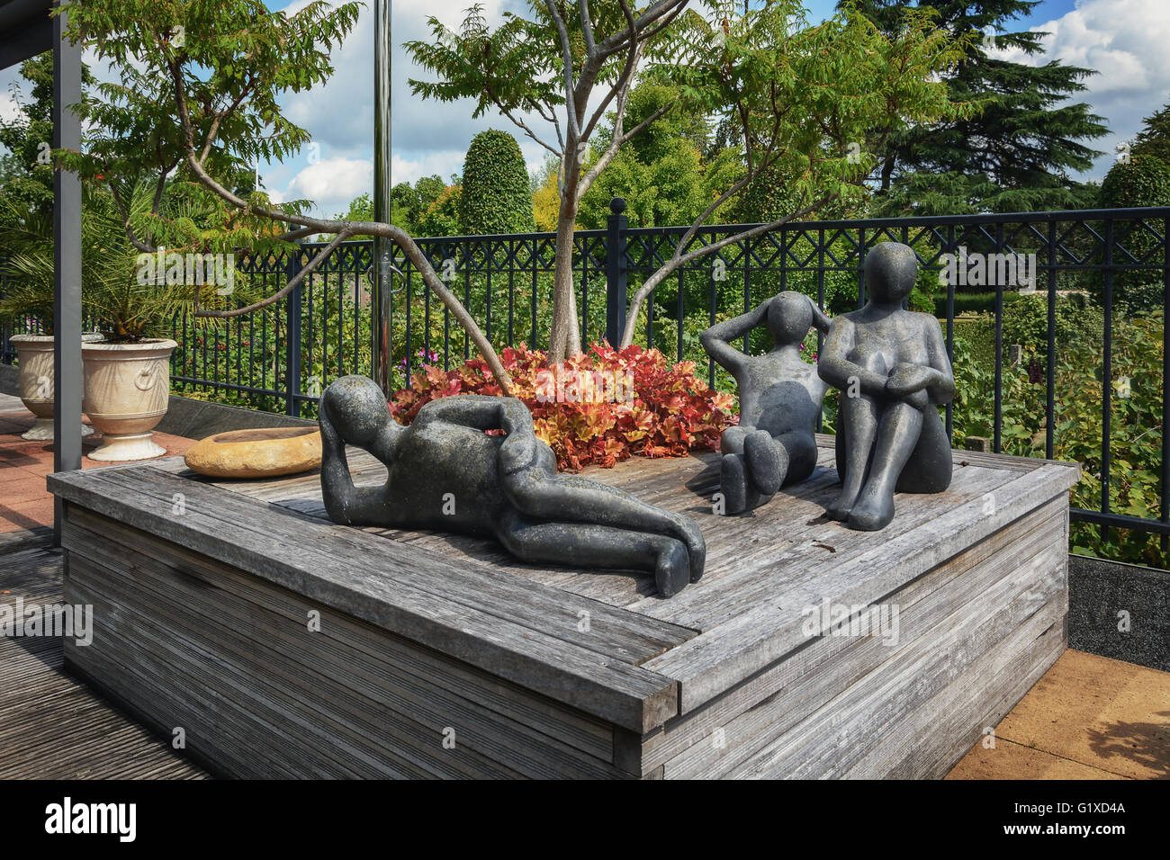 Relaxing statues in the garden Stock Photo - Alamy