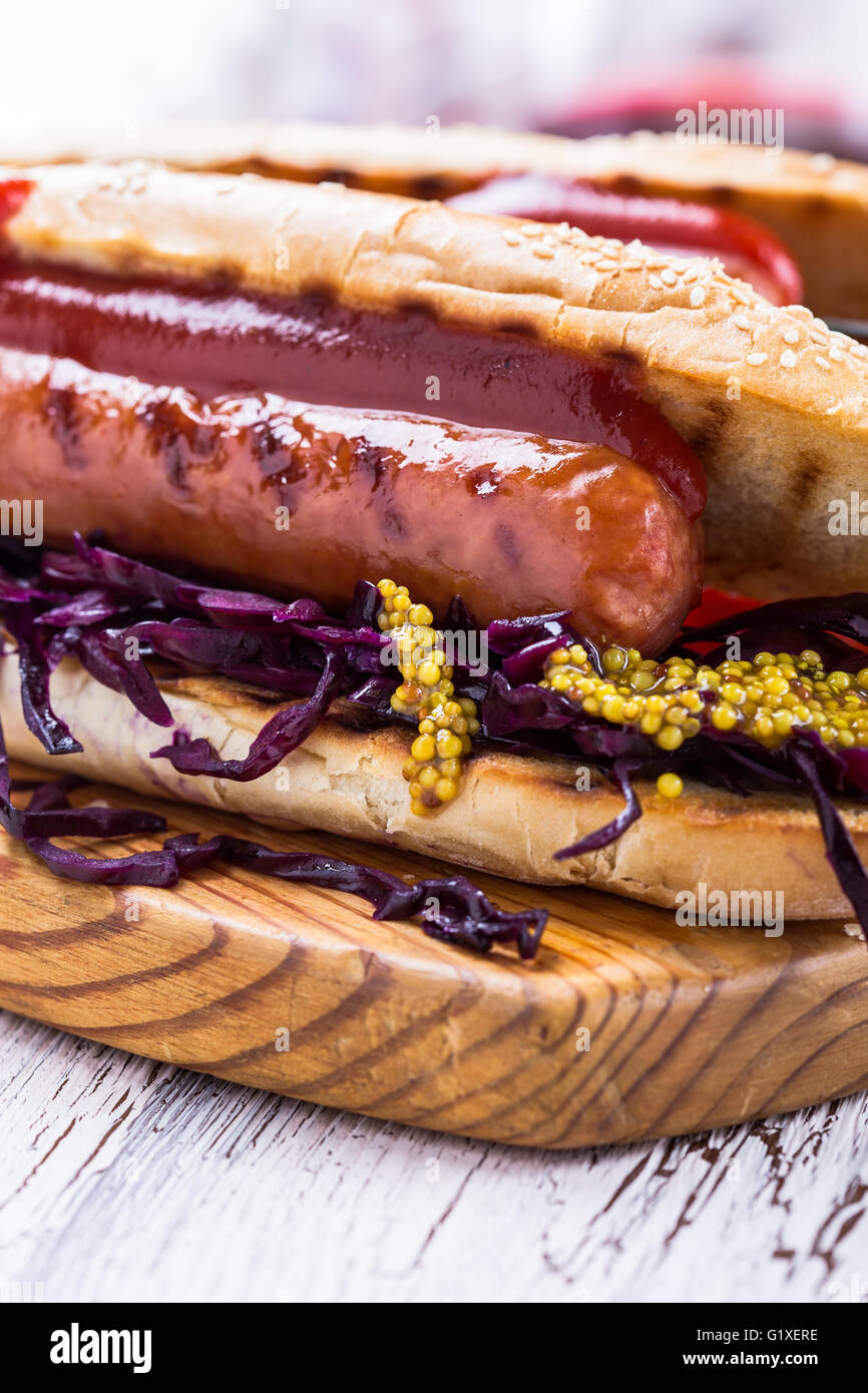 Grilled sausage sandwich with sweet red cabbage coleslaw, mustard and ...
