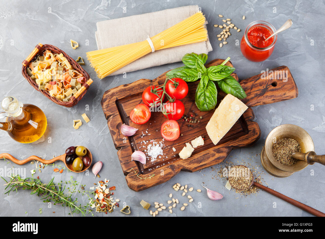 Italian food background with vine tomatoes, basil, spaghetti, olives ...