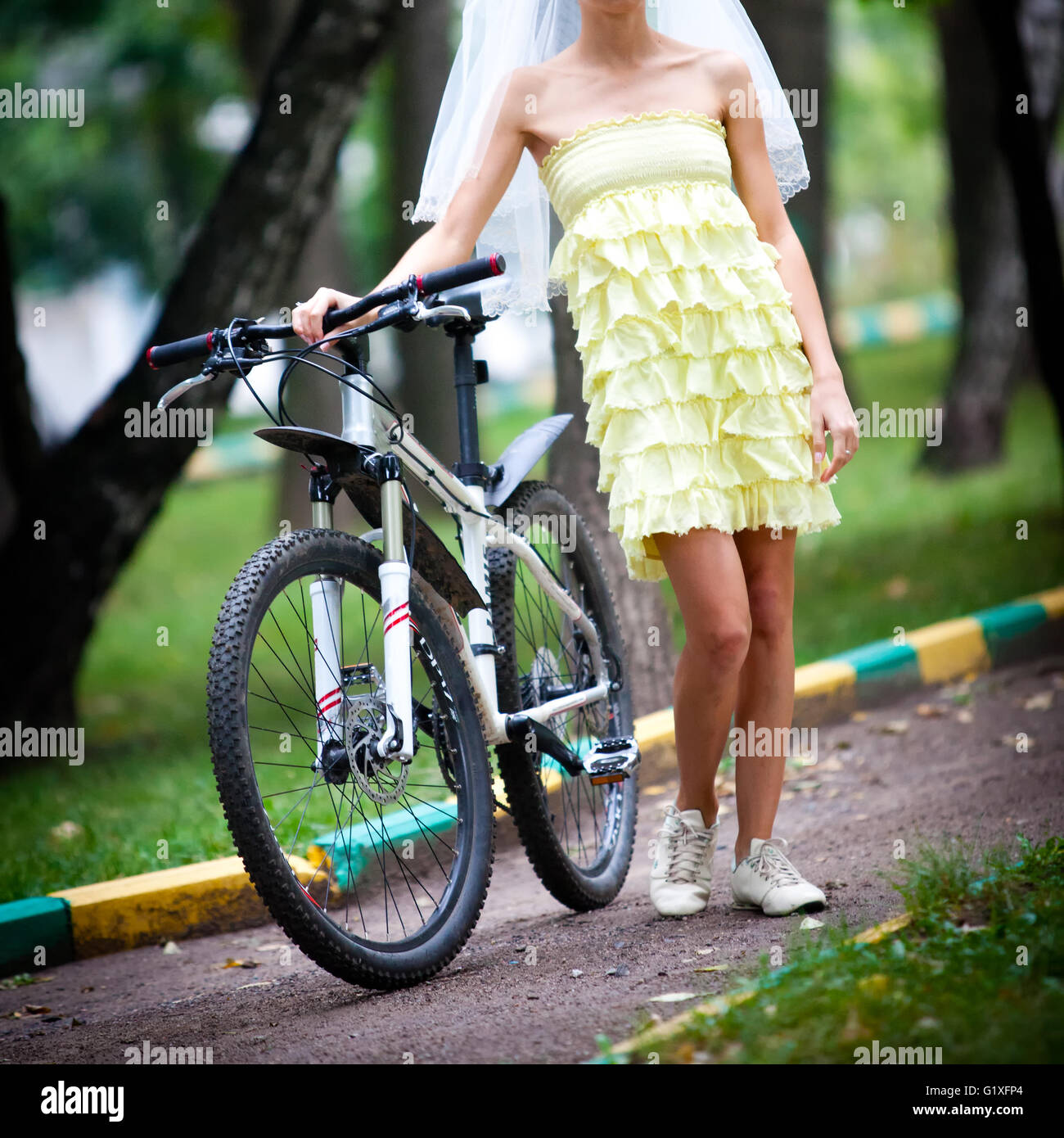 Bride on a bicycle being flirty Stock Photo - Alamy
