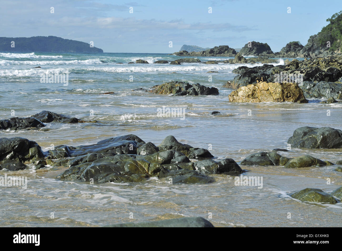 Sandy beach and rocks Stock Photo - Alamy