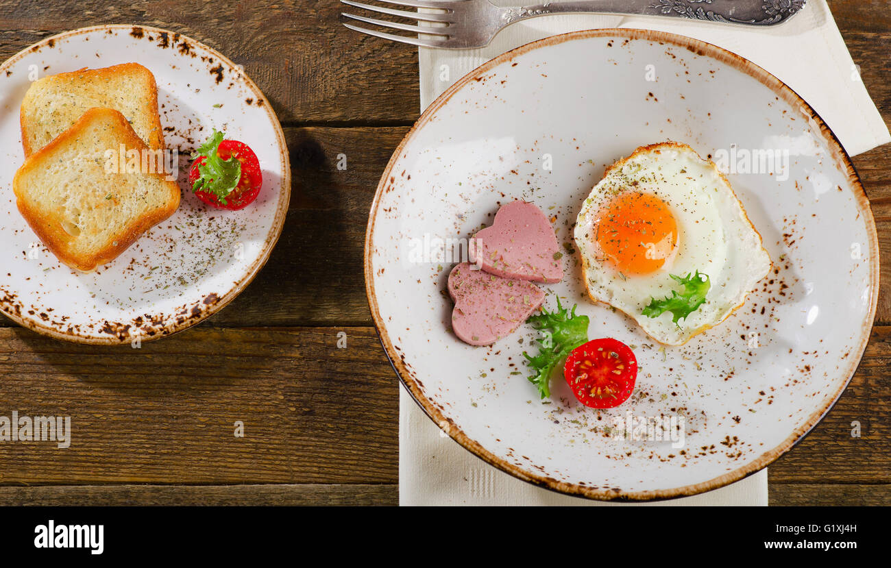Traditional Breakfast with fried egg. Top view Stock Photo - Alamy