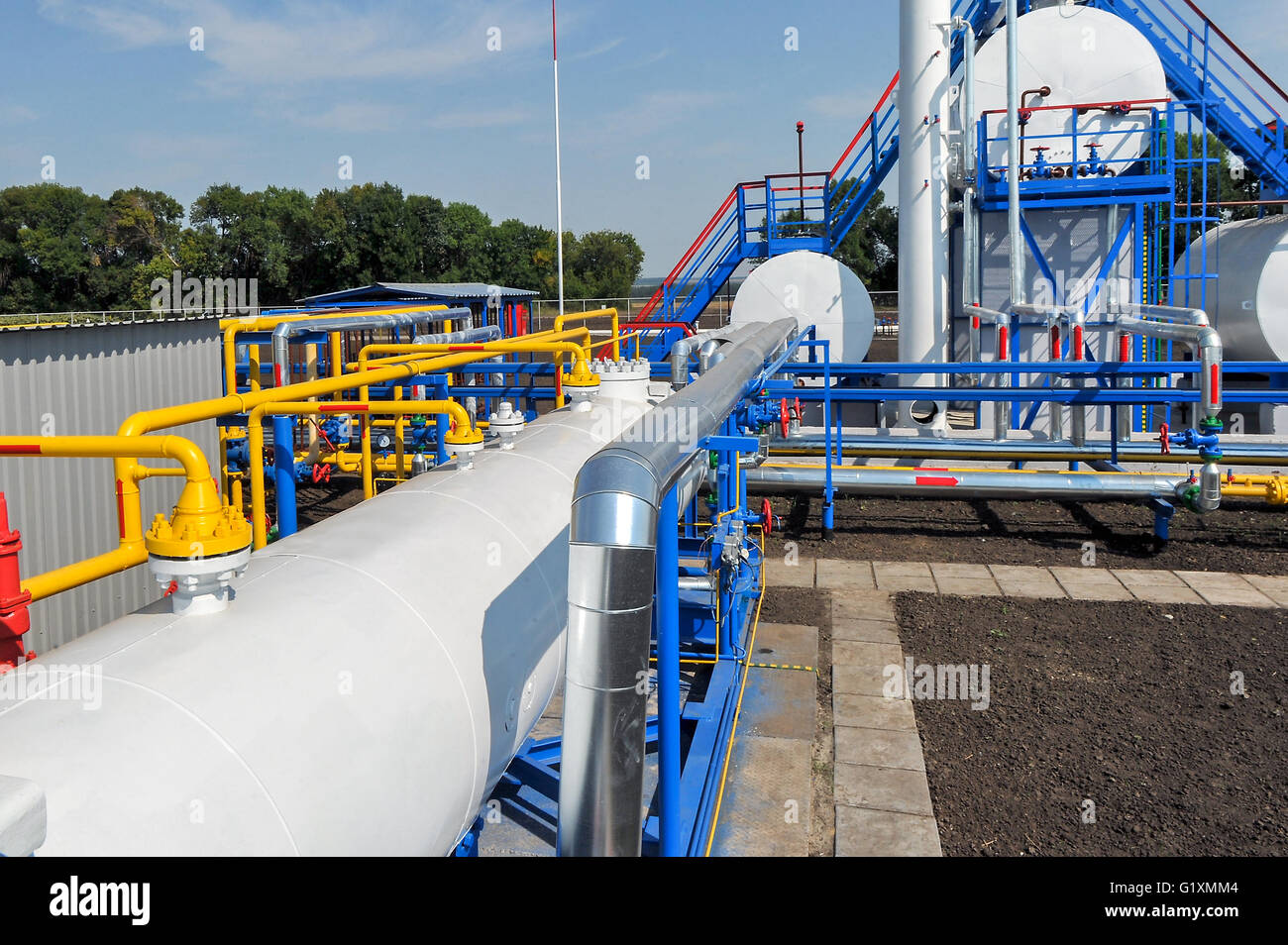 White fuel tanks and color gas pipes in natural gas treatment plant in ...