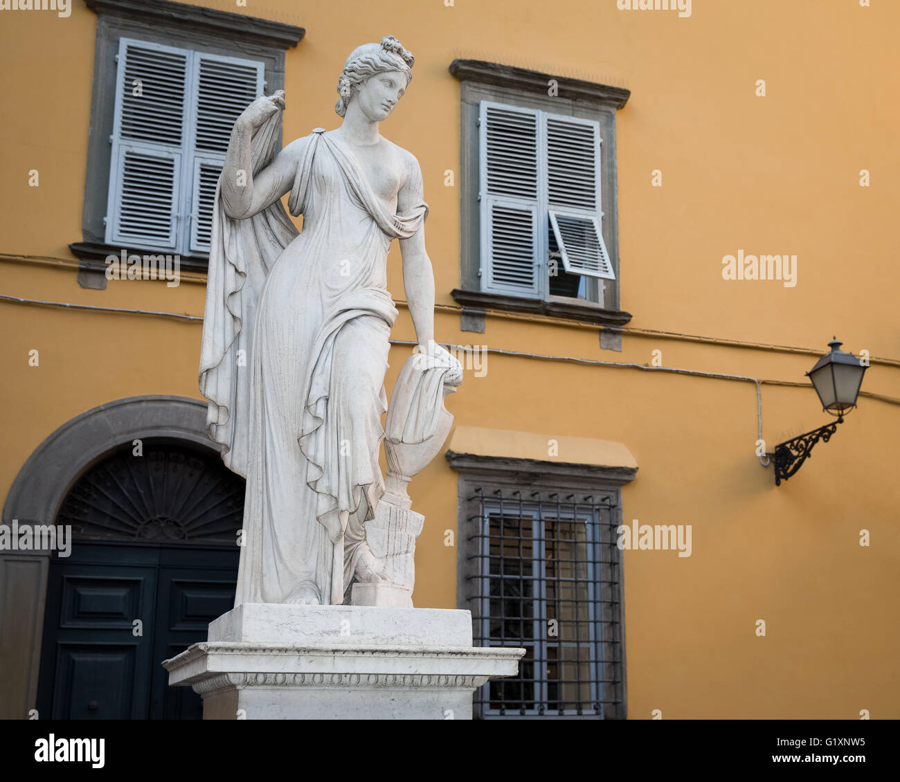 Ancient statue of female figure with an amphora atop a water fountain ...