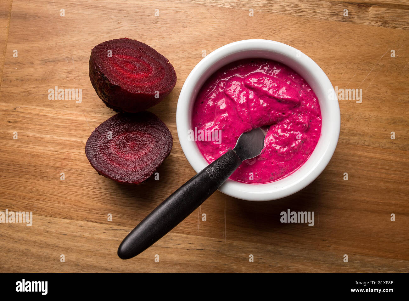 Beet paste in a wooden tray served with beet cut in half Stock Photo ...