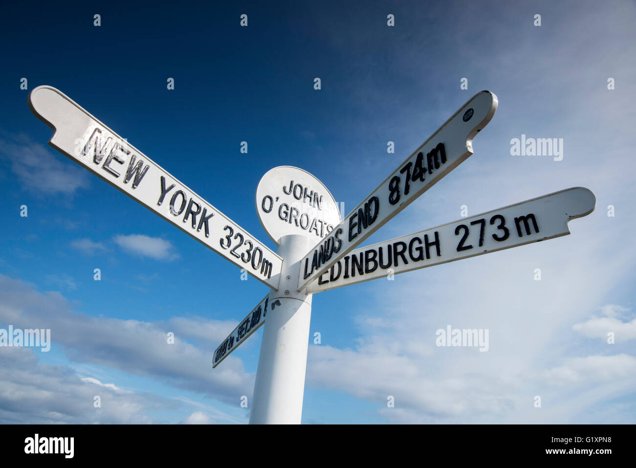 Iconic signpost against a blue sky at John O'Groats, Caithness in ...