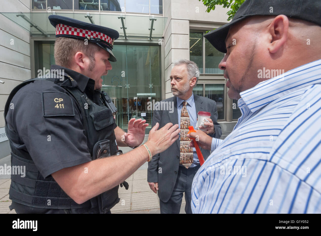London, UK. 20th May 2016. The police officer watching the protest ...
