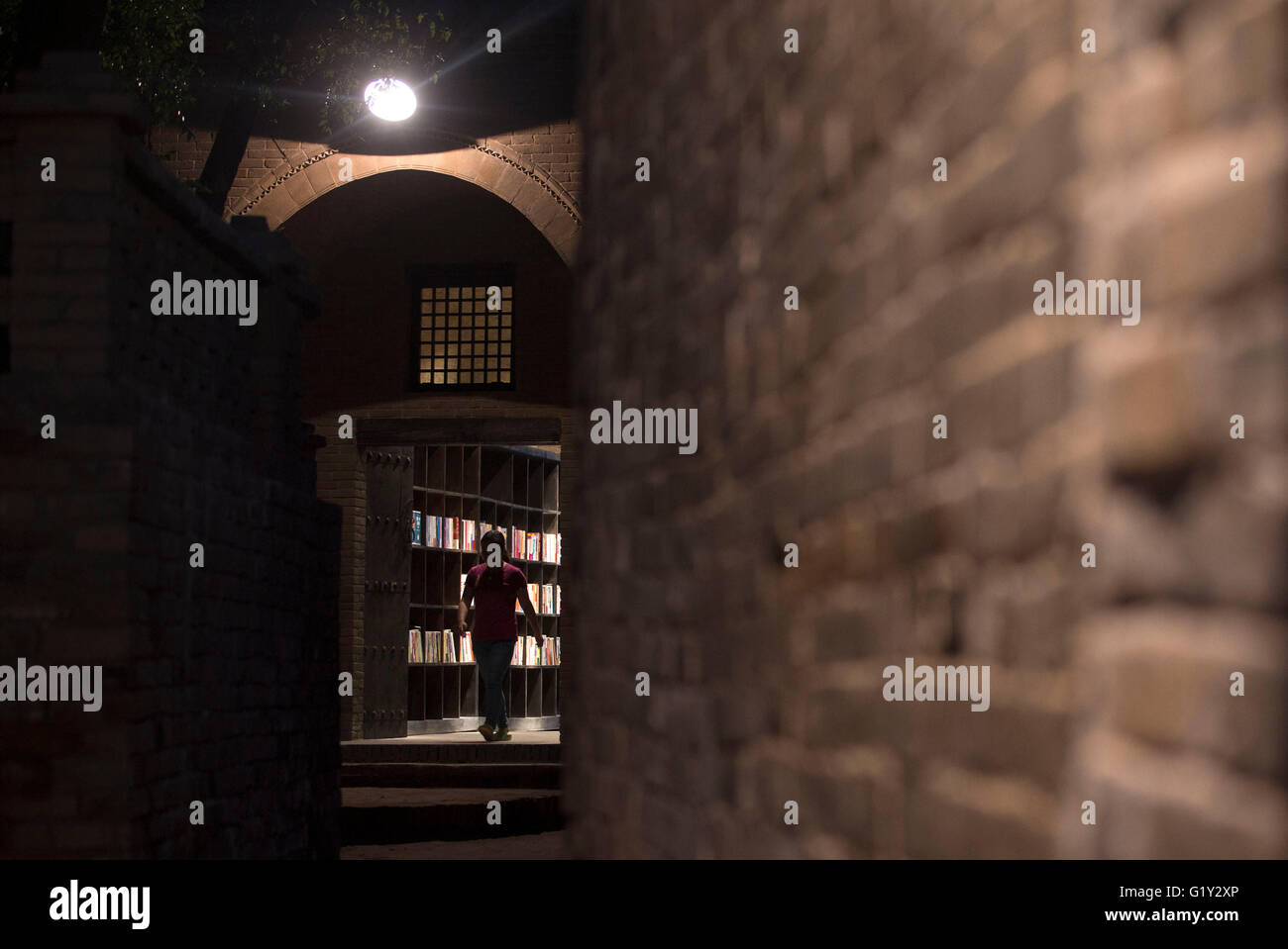 Mengzhou, China's Henan Province. 20th May, 2016. A villager steps out ...
