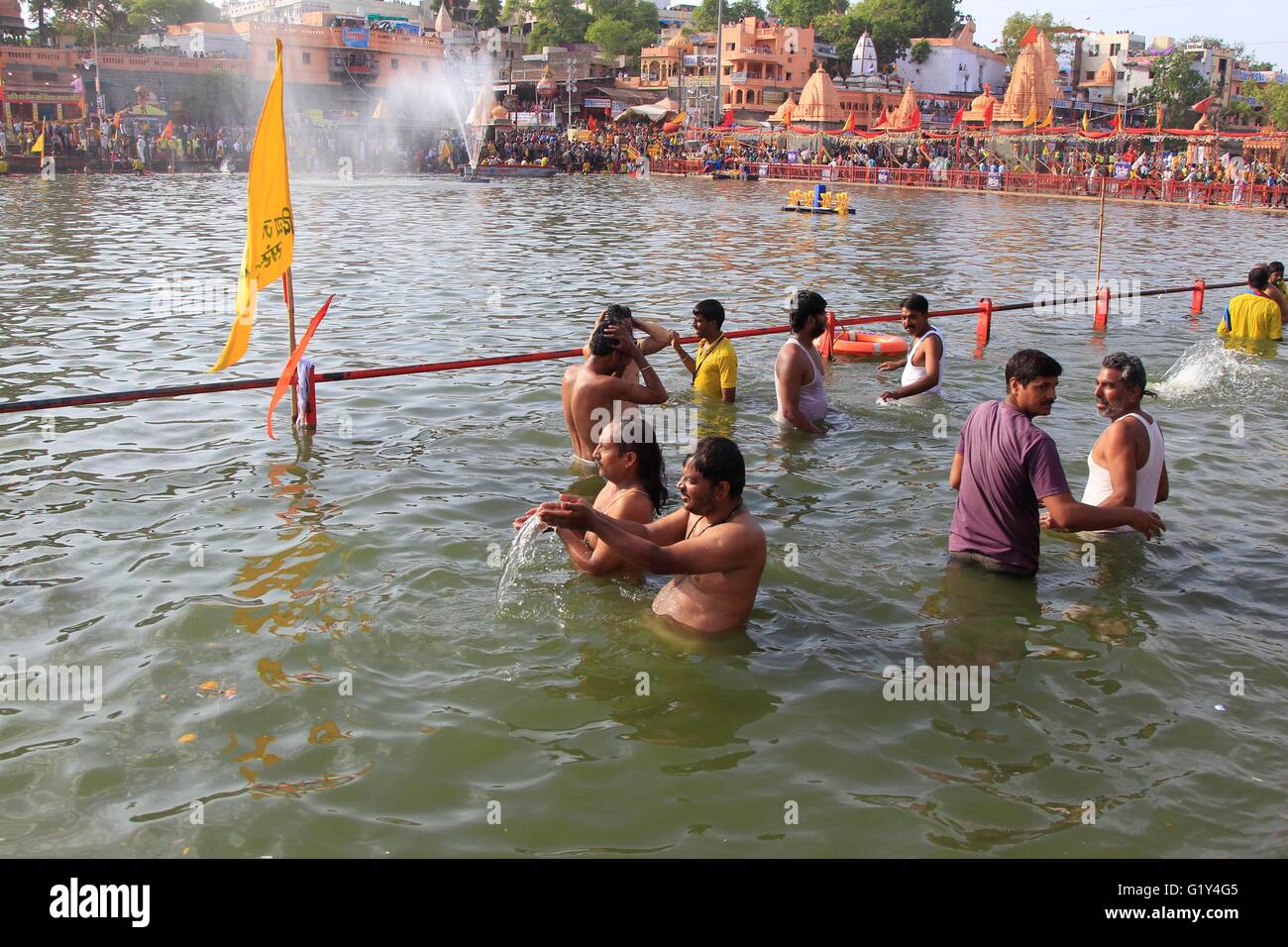India. 21st May, 2016. Naga Sadhu or holy men takes holy bath in the ...
