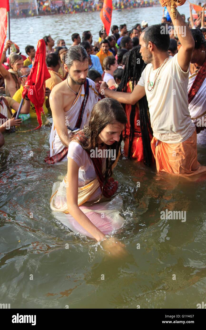 India. 21st May, 2016. Naga Sadhu or holy men takes holy bath in the ...