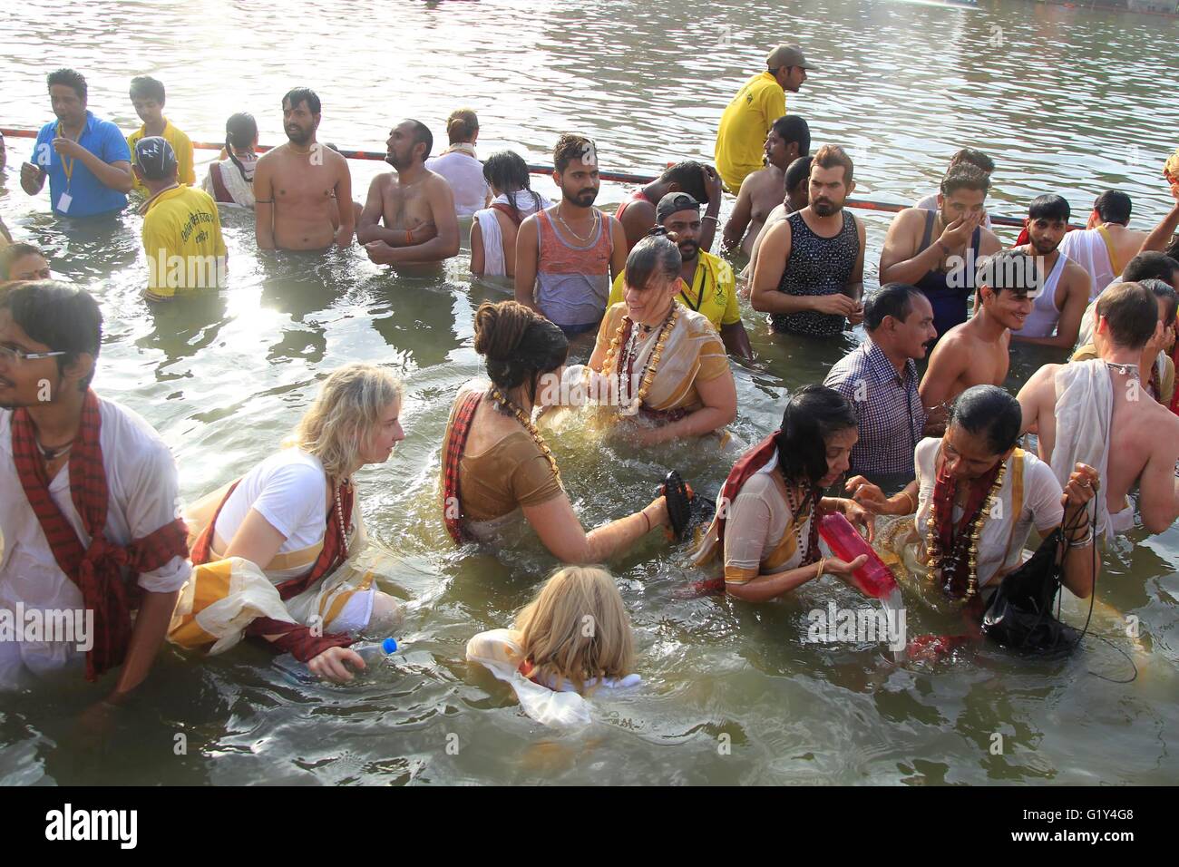 India. 21st May, 2016. Naga Sadhu or holy men takes holy bath in the ...