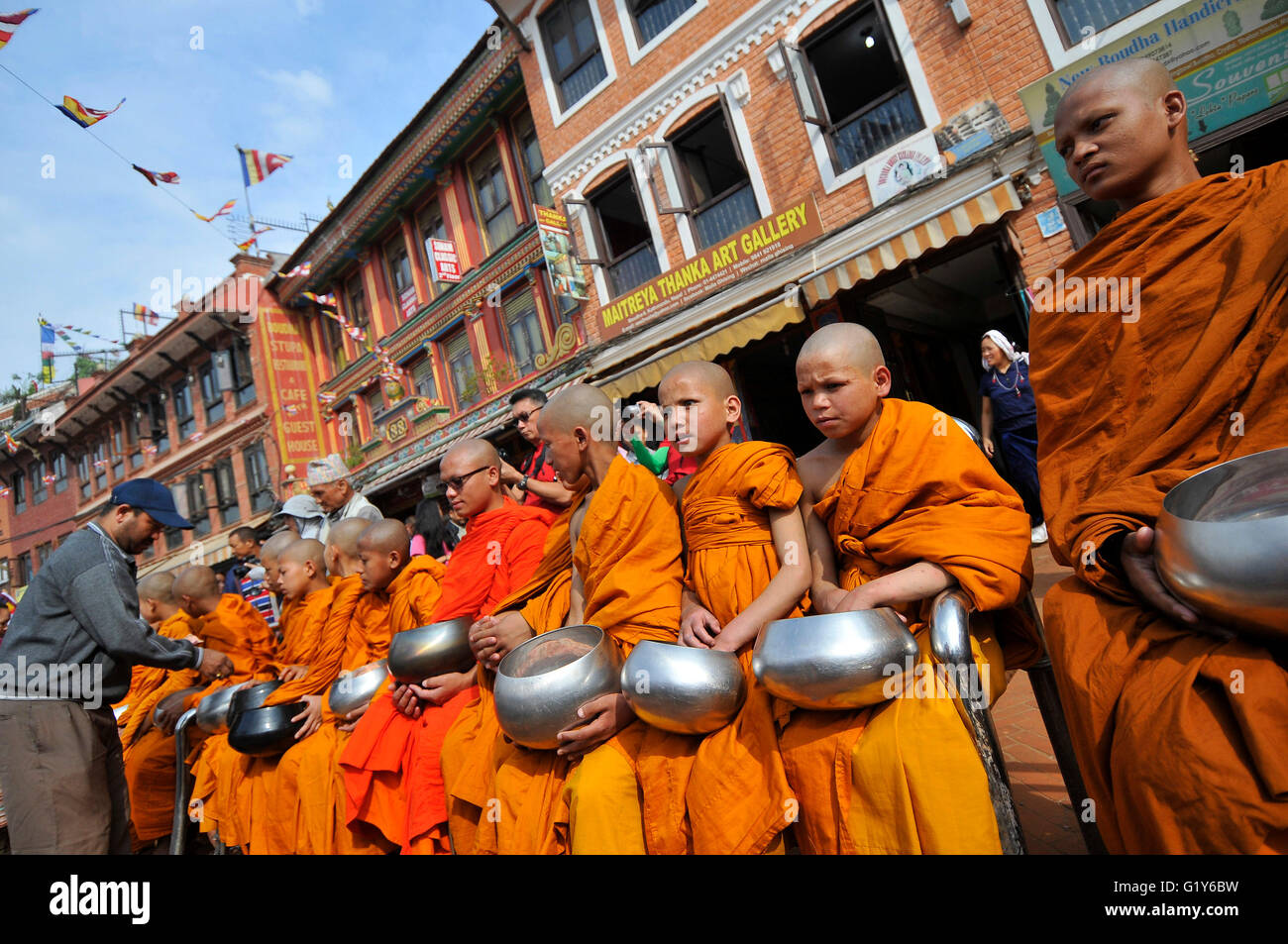 Devotees offering holy grains and money to Buddhist monks at the ...