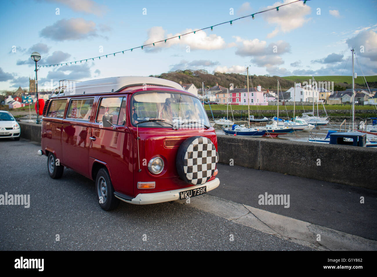 A classic red 1972 Volkswagen VW T2 (type 2) camper van, parked on the ...