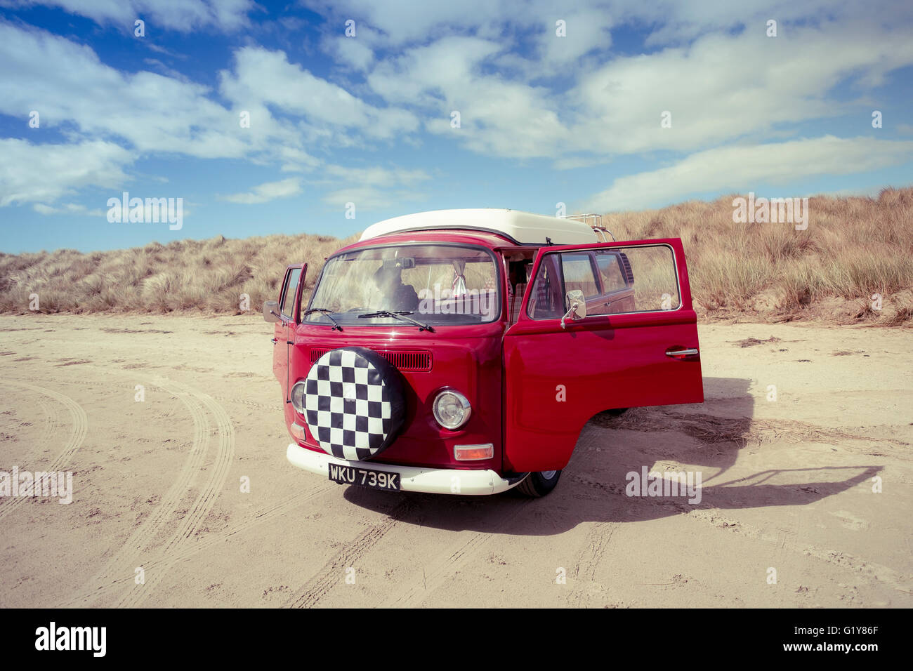 A woman with her classic red 1972 Volkswagen VW T2 (type 2) camper van ...