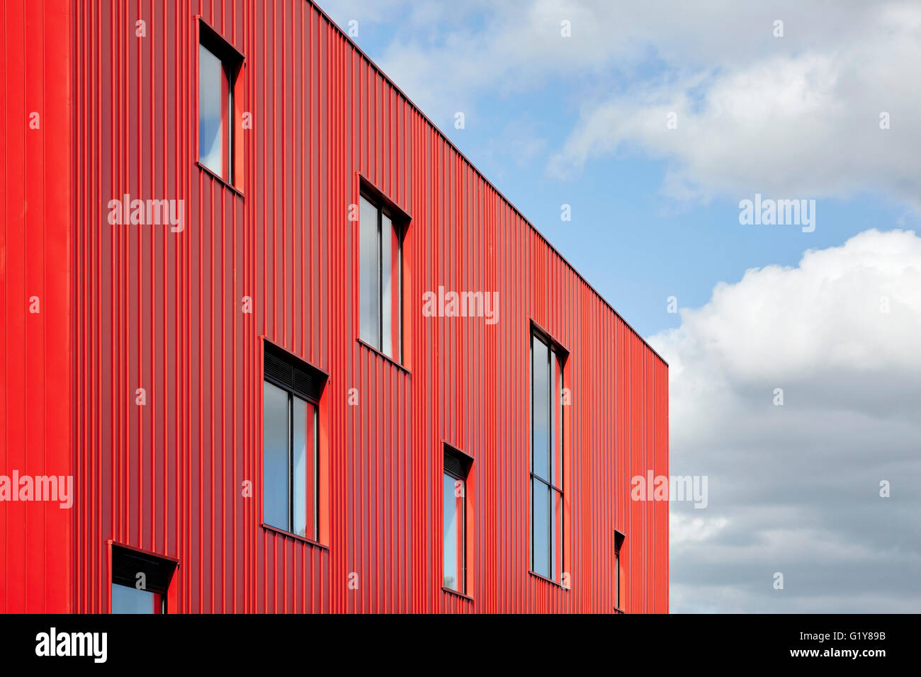 Exterior facade made of red profiled steel sheets. Plymouth Creative ...