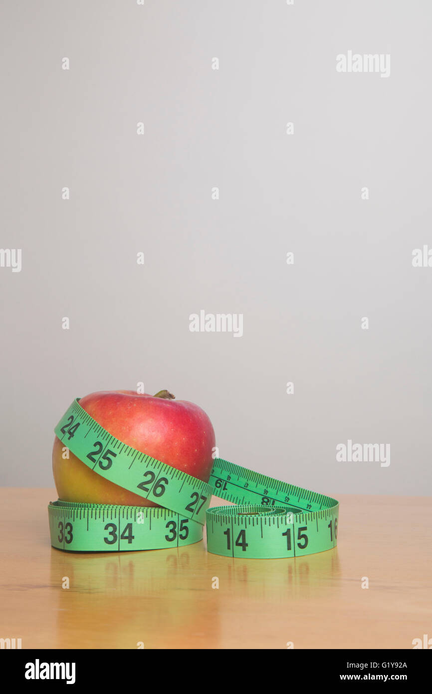 Measuring tape around apple Stock Photo - Alamy