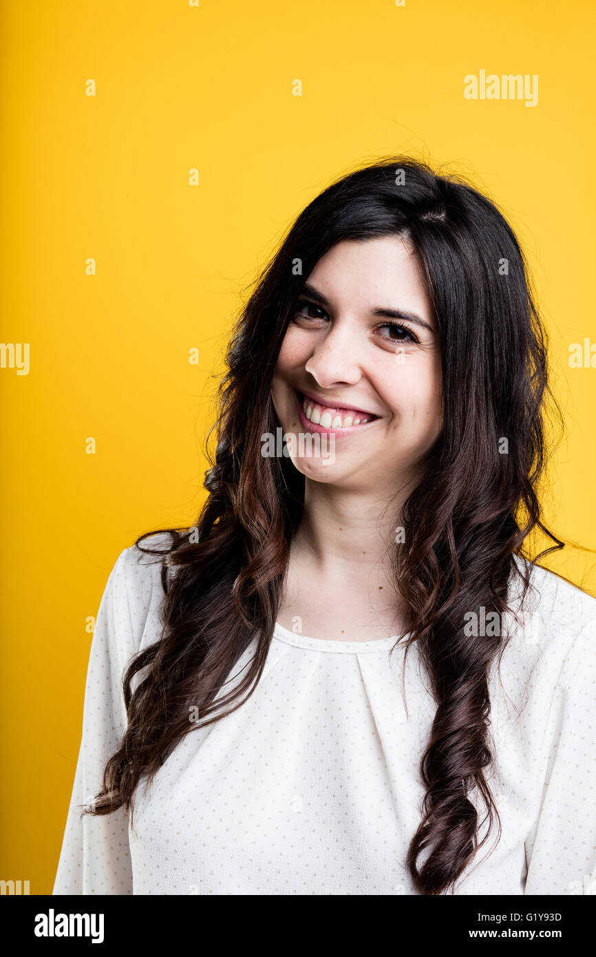 portrait of a smiling woman on yellow background Stock Photo - Alamy
