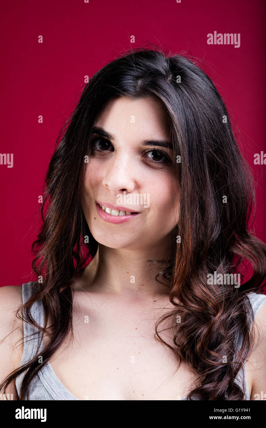 little smile by a woman on purple background Stock Photo - Alamy
