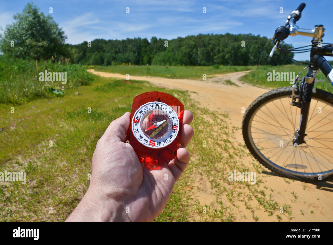 With a compass and a Bicycle front fork. Orientation during a bike ride ...