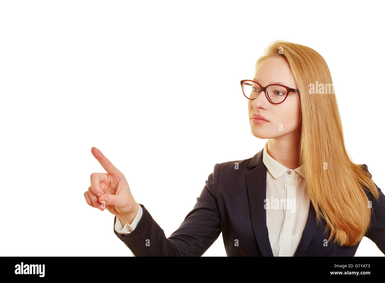 Blonde business woman touching an invisible touch screen with her ...