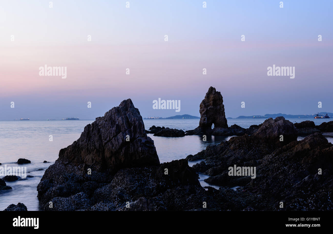 The sea with rocks after sunset Stock Photo - Alamy